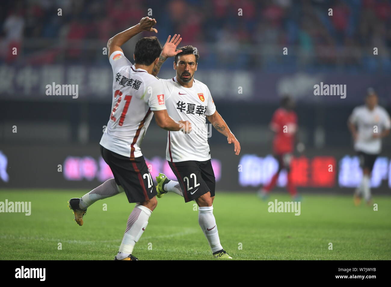Argentine football player Ezequiel Lavezzi, right, of Hebei China ...