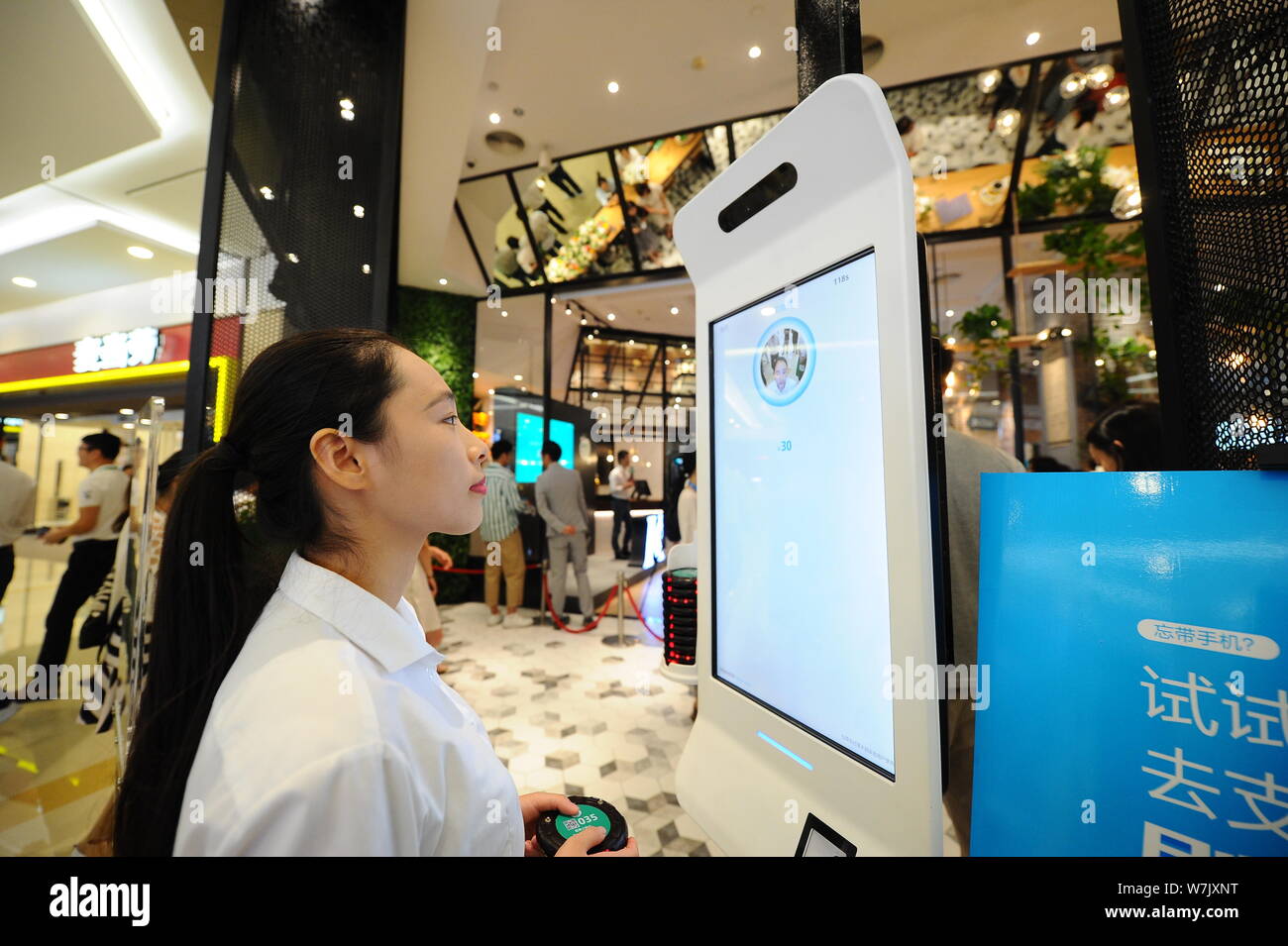 A customer looks at an ordering machine with the function of ordering ...