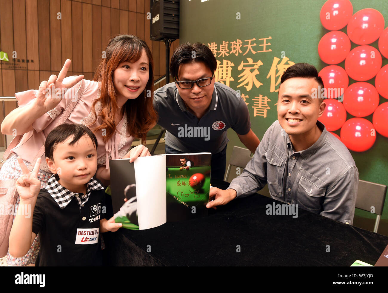 Hong Kong snooker player Marco Fu, right, poses with fans during a ...