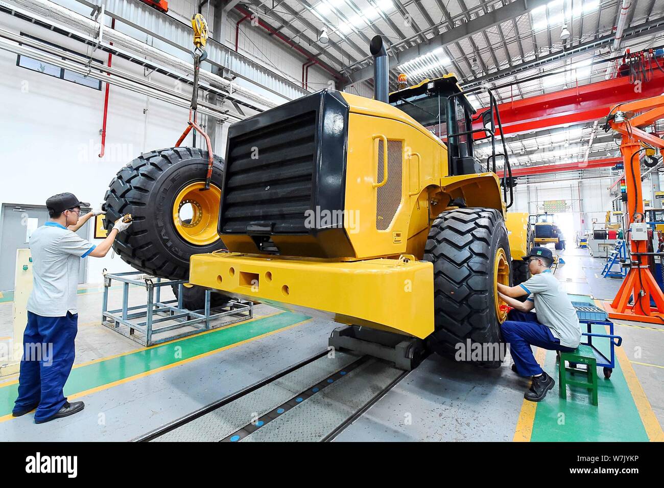 --FILE--Chinese workers produce electric products on the assembly line at a factory in Huaying ...