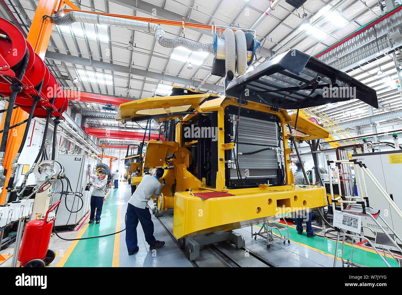 --FILE--Chinese workers produce electric products on the assembly line at a factory in Huaying ...