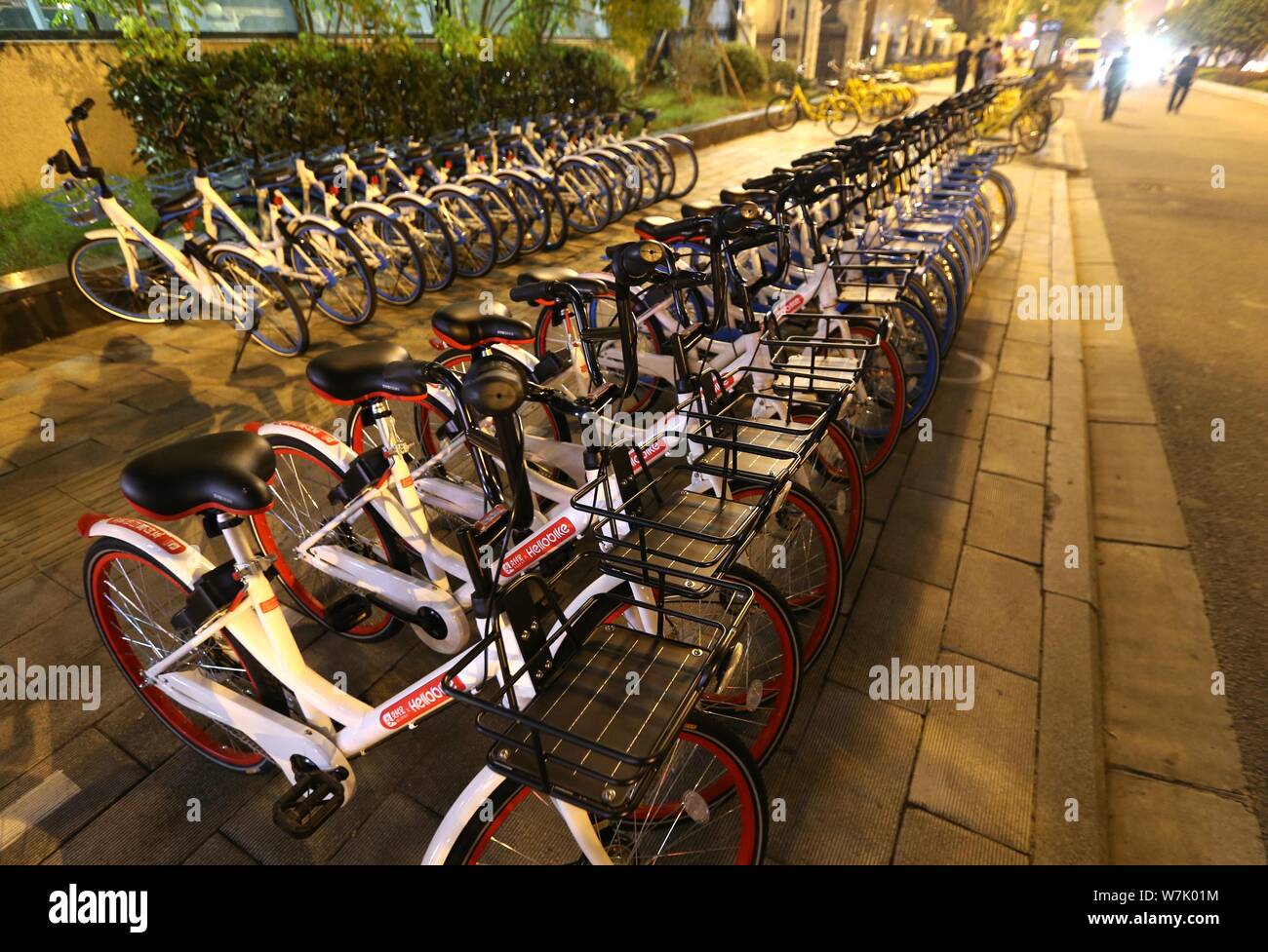 Bicycles of Chinese bike-sharing services are lined up on a street in ...