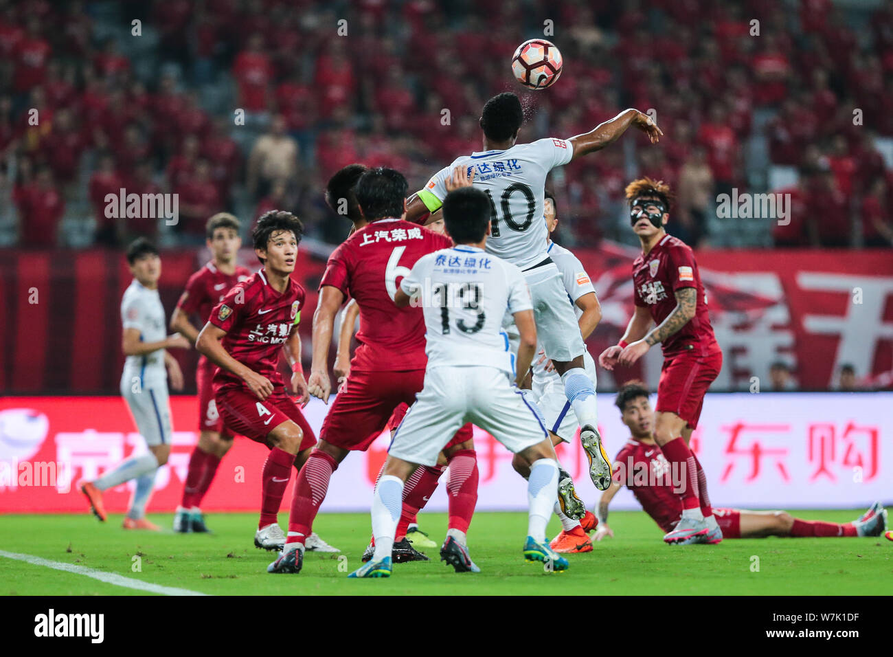 Nigerian football player John Obi Mikel, top, of Tianjin TEDA heads the ...