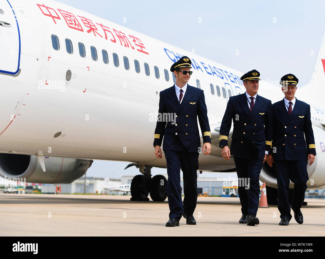 --FILE--Foreign pilots walk in front of a jet plane of China Eastern ...