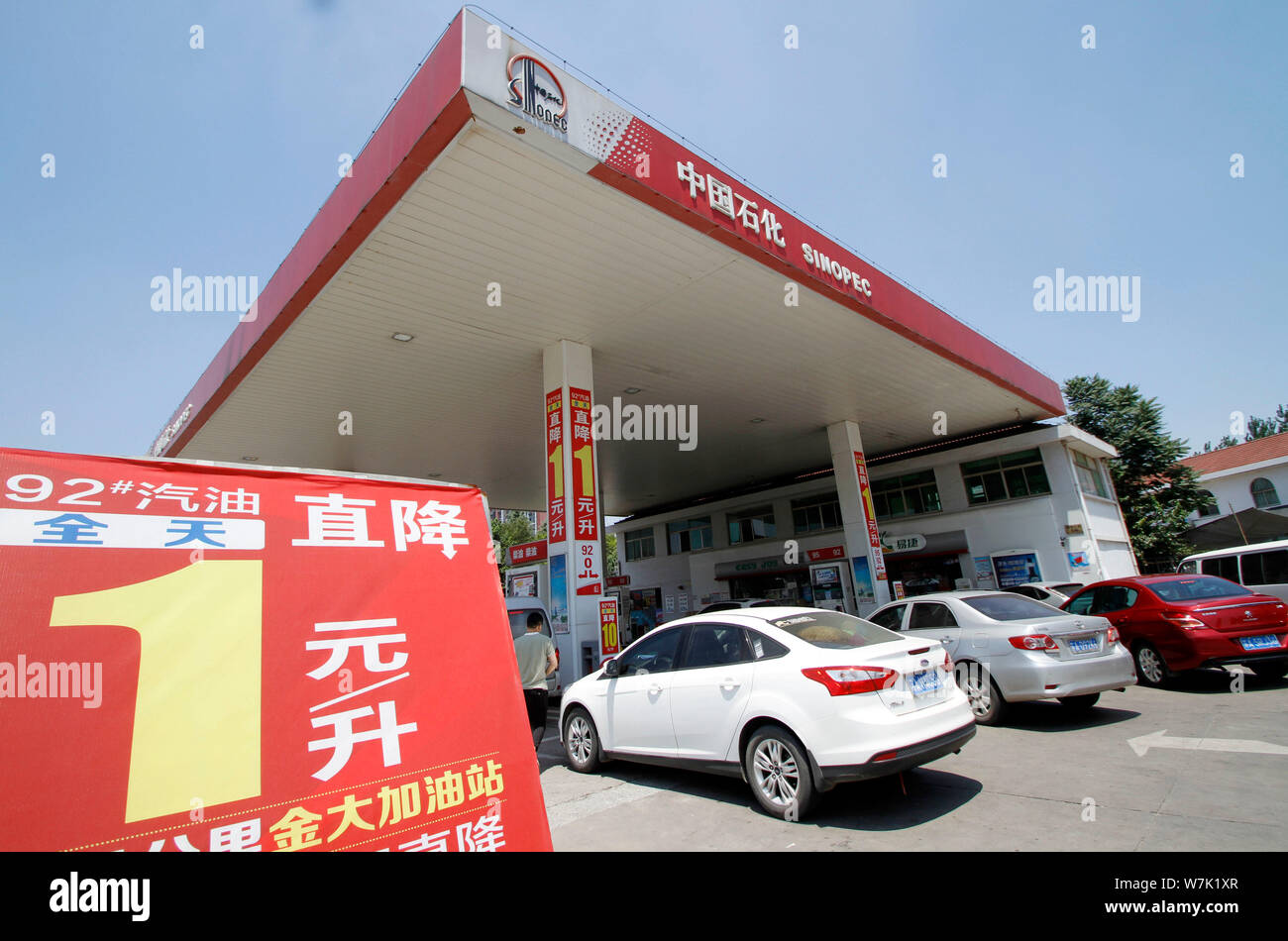 --FILE--Cars queue up to be refueled at a gas station of Sinopec in ...