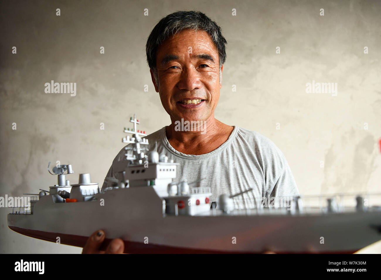 Chinese enthusiast Guo Changhai shows a model of Chinese Navy vessel ...