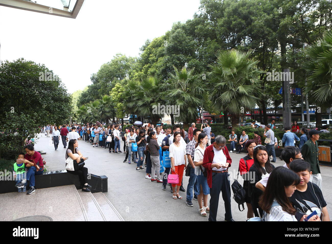 Chinese customers wait in long queue to buy mooncakes in front of a ...