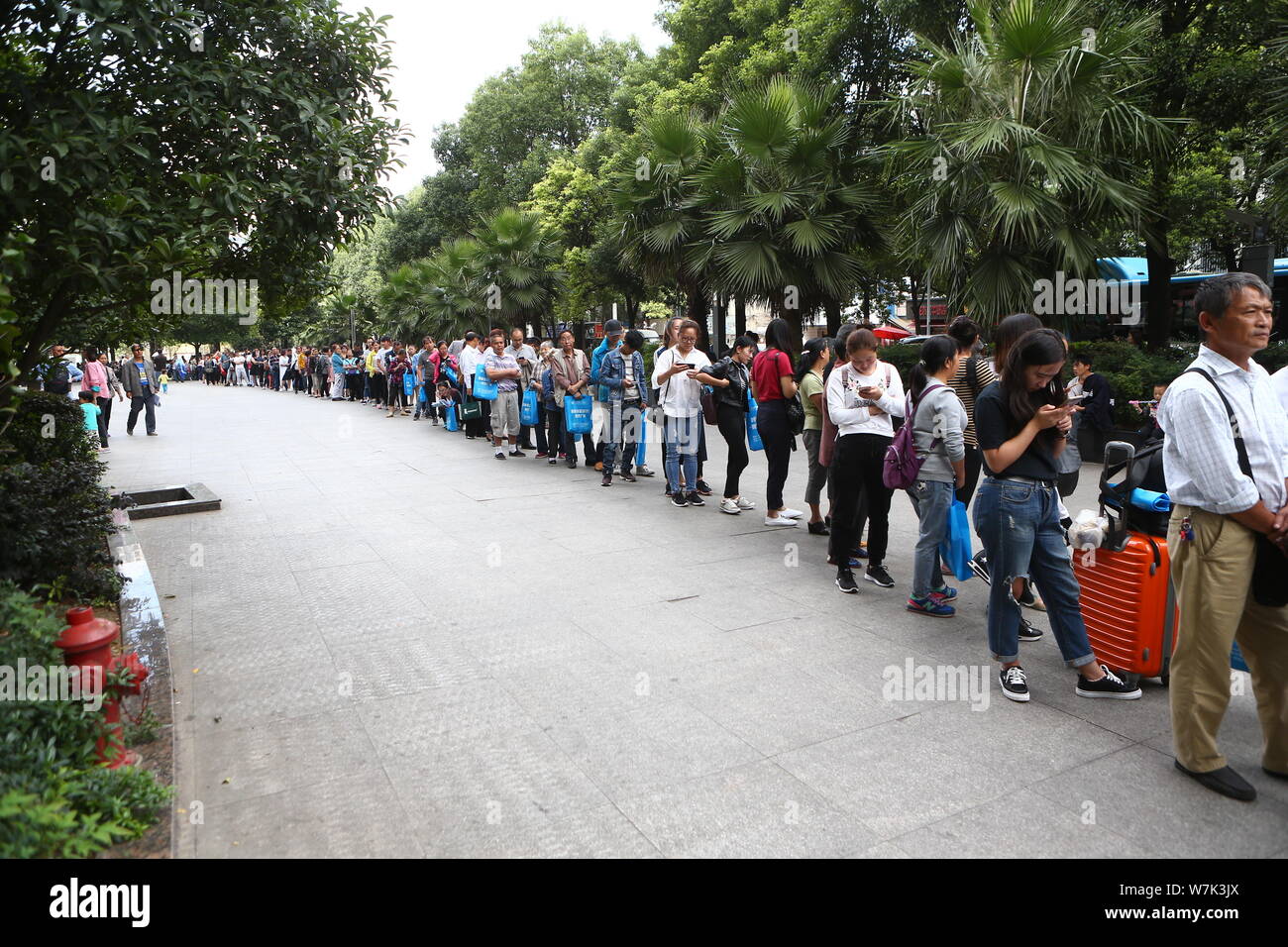 Chinese customers wait in long queue to buy mooncakes in front of a ...