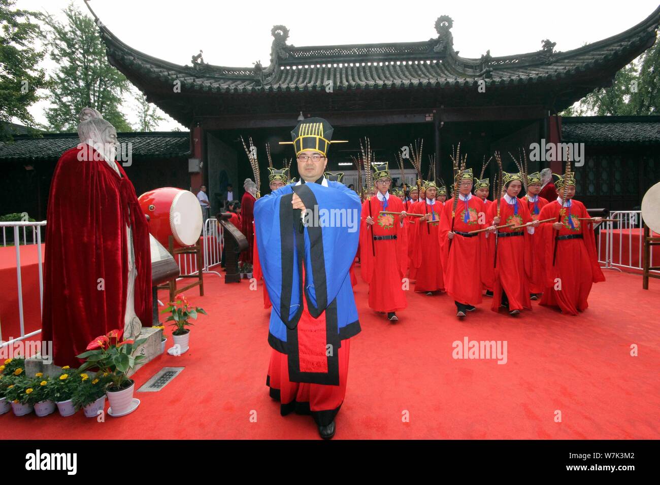 Participants dressed in traditional costumes perform a ritual to mark ...