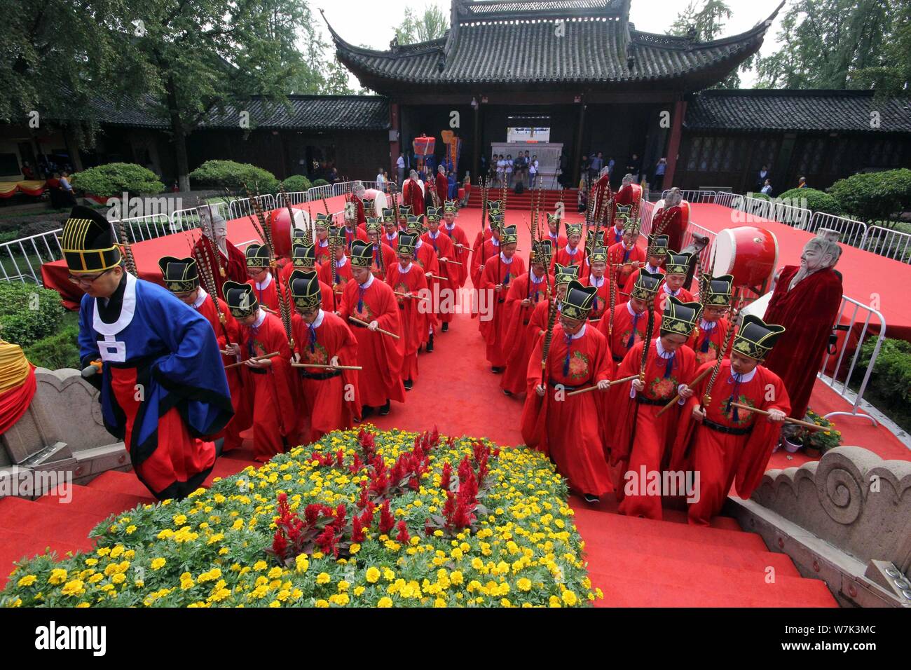 Participants dressed in traditional costumes perform a ritual to mark ...