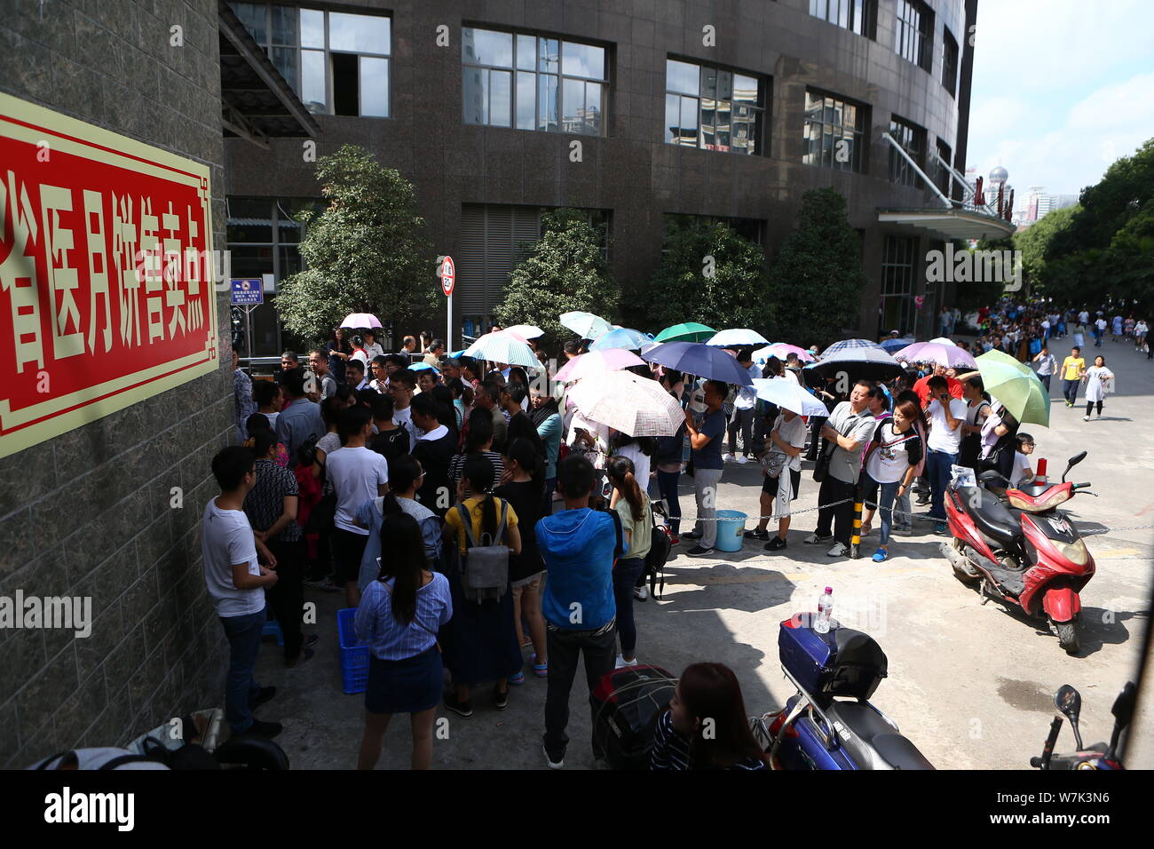Chinese customers wait in long queue to buy mooncakes in front of a ...