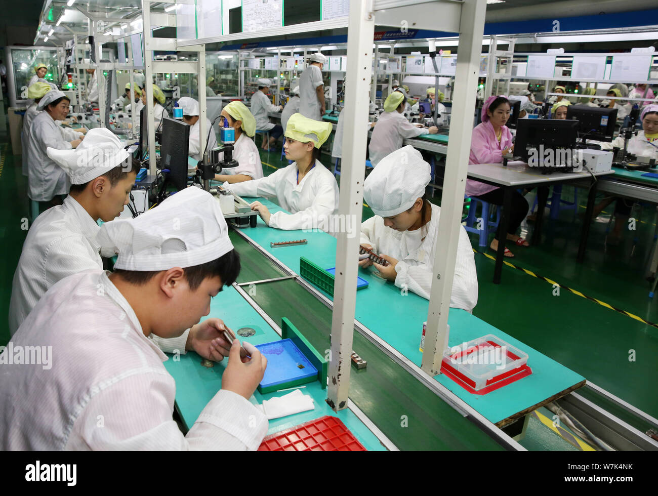 --FILE--Female Chinese workers produce electric products on the ...