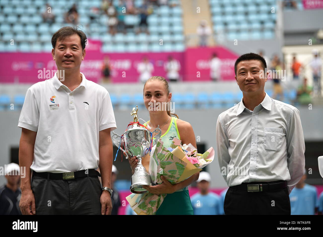 Aleksandra Krunic of Serbia, center, poses with her champion trophy ...