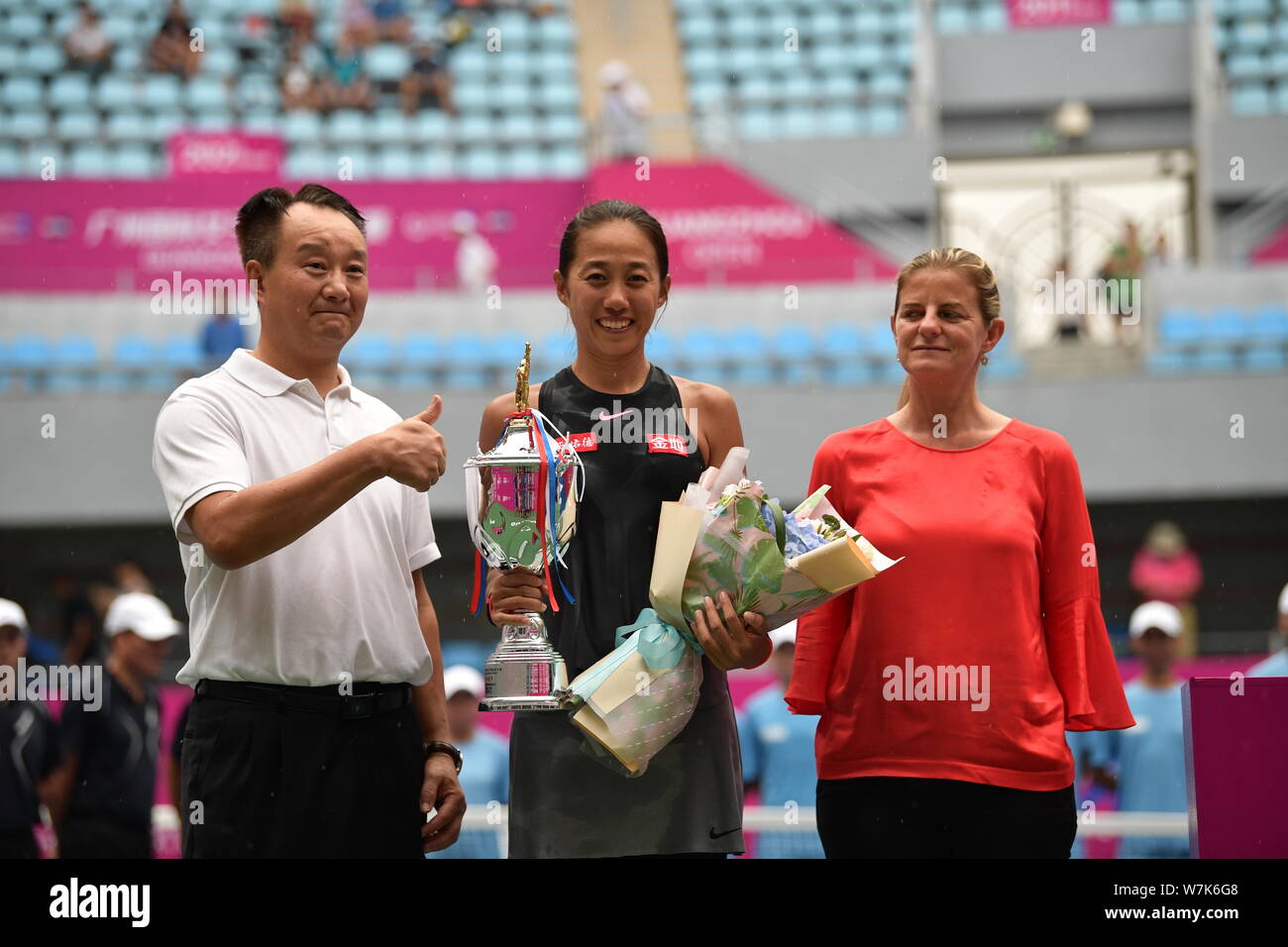 Zhang Shuai of China, center, poses with her champion trophy after the ...