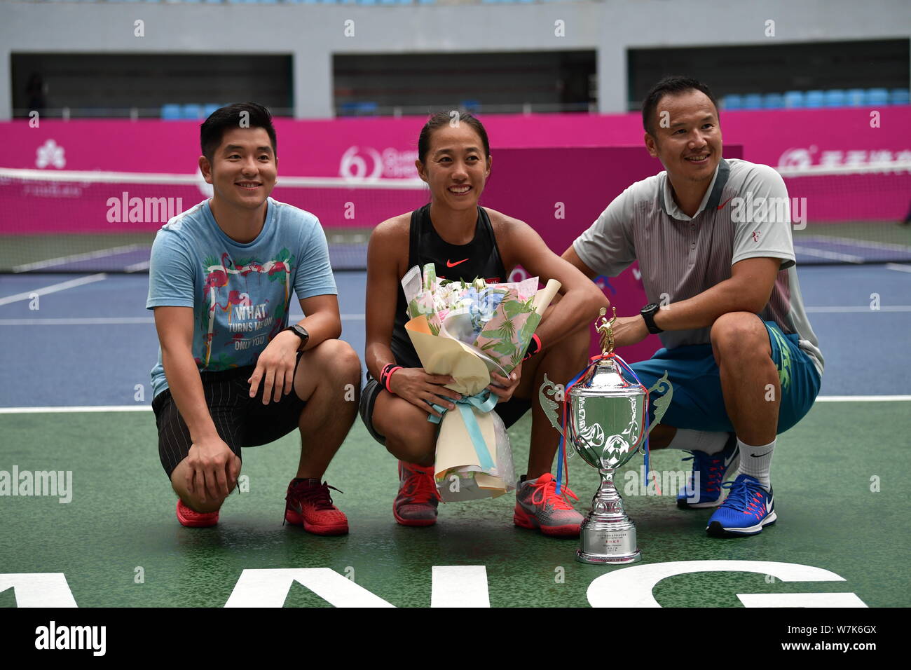 Zhang Shuai of China, center, poses with her champion trophy after the ...