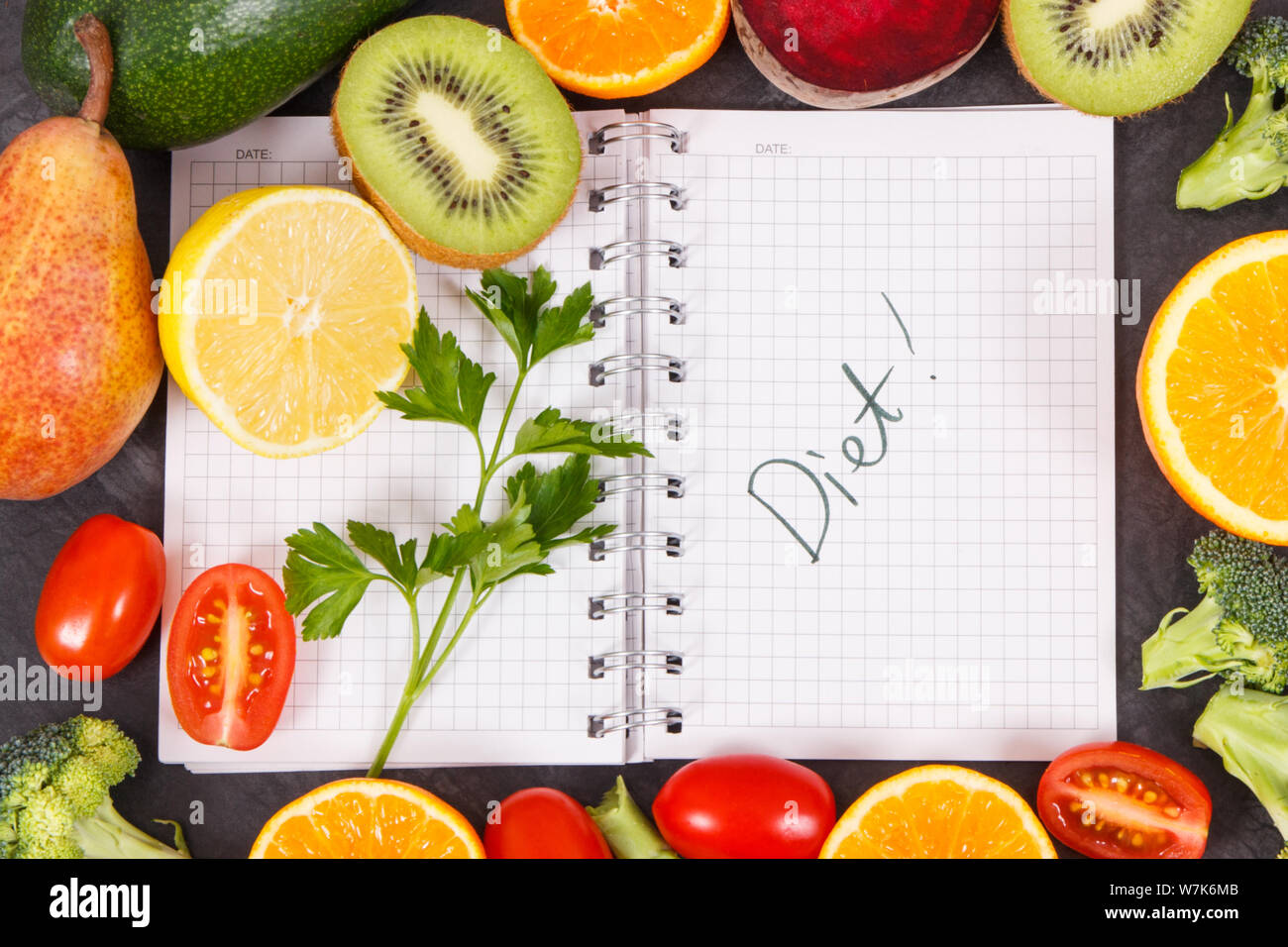 Word diet written in notepad and fresh ripe fruits with vegetables ...