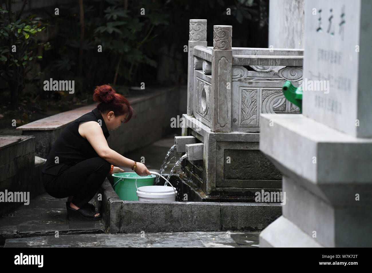 A nearby resident fetches the well water from the 600-year-old Yujing ...