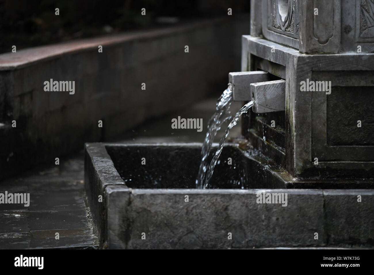 View of the 600-year-old Yujing Ancient Well with well water flowing at ...