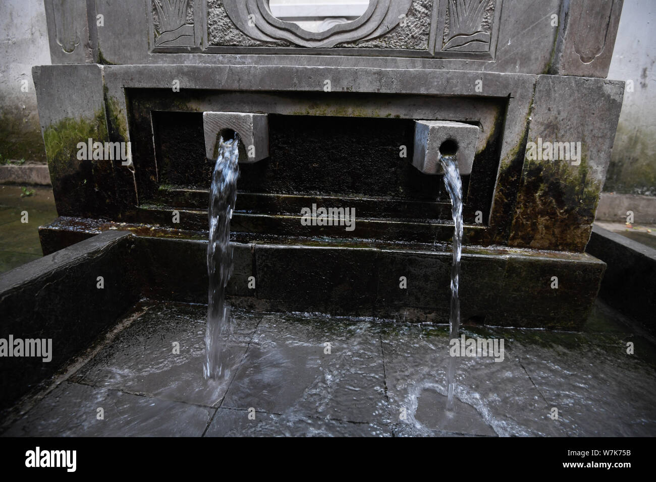 View of the 600-year-old Yujing Ancient Well with well water flowing at ...
