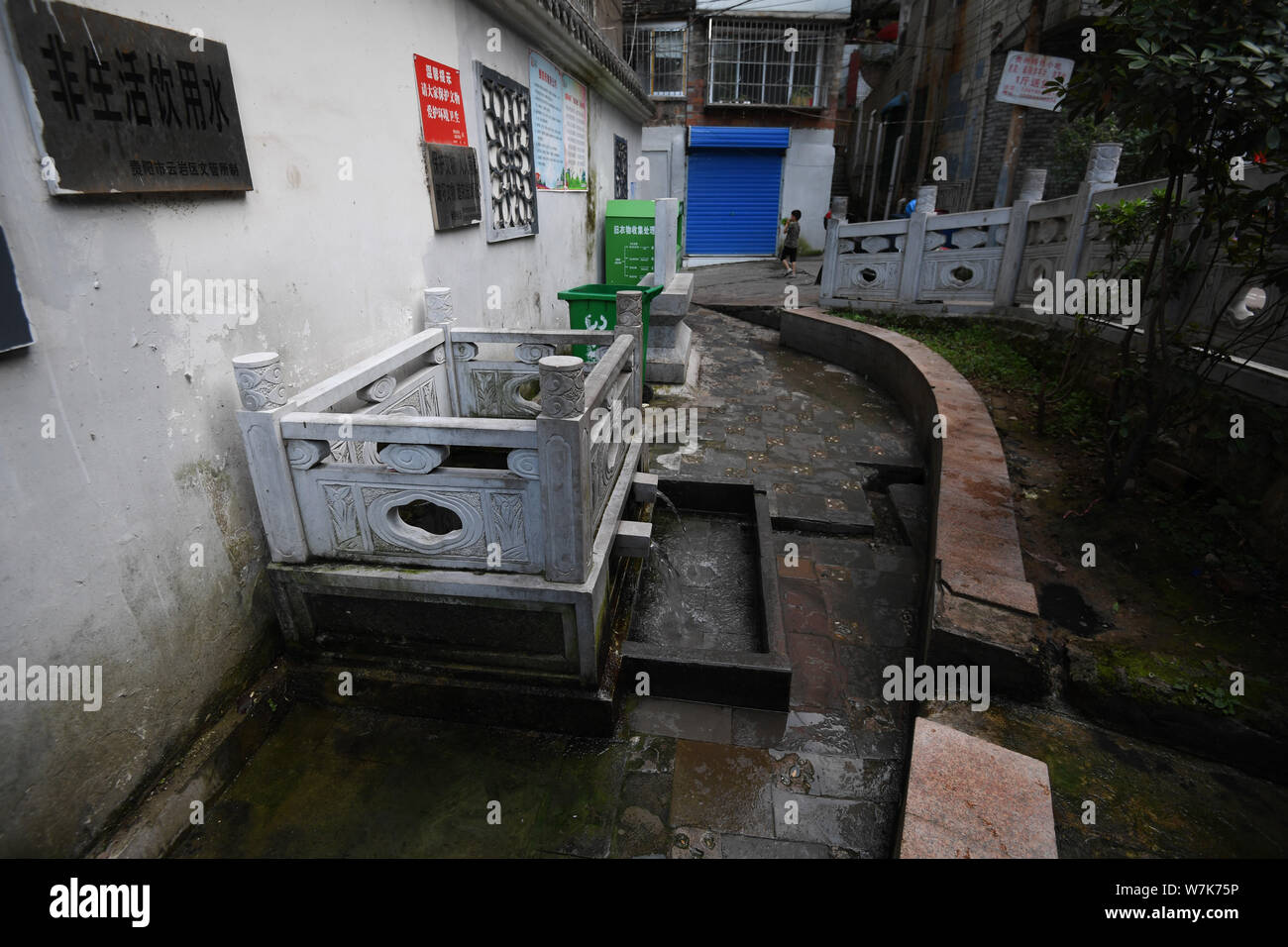 View of the 600-year-old Yujing Ancient Well with well water flowing at ...