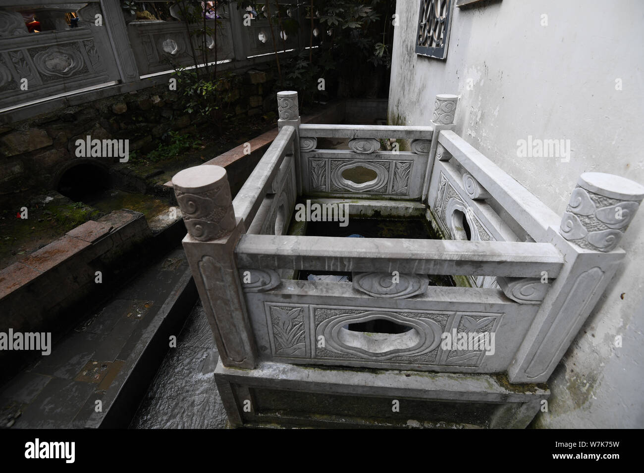 View of the 600-year-old Yujing Ancient Well with well water flowing at ...