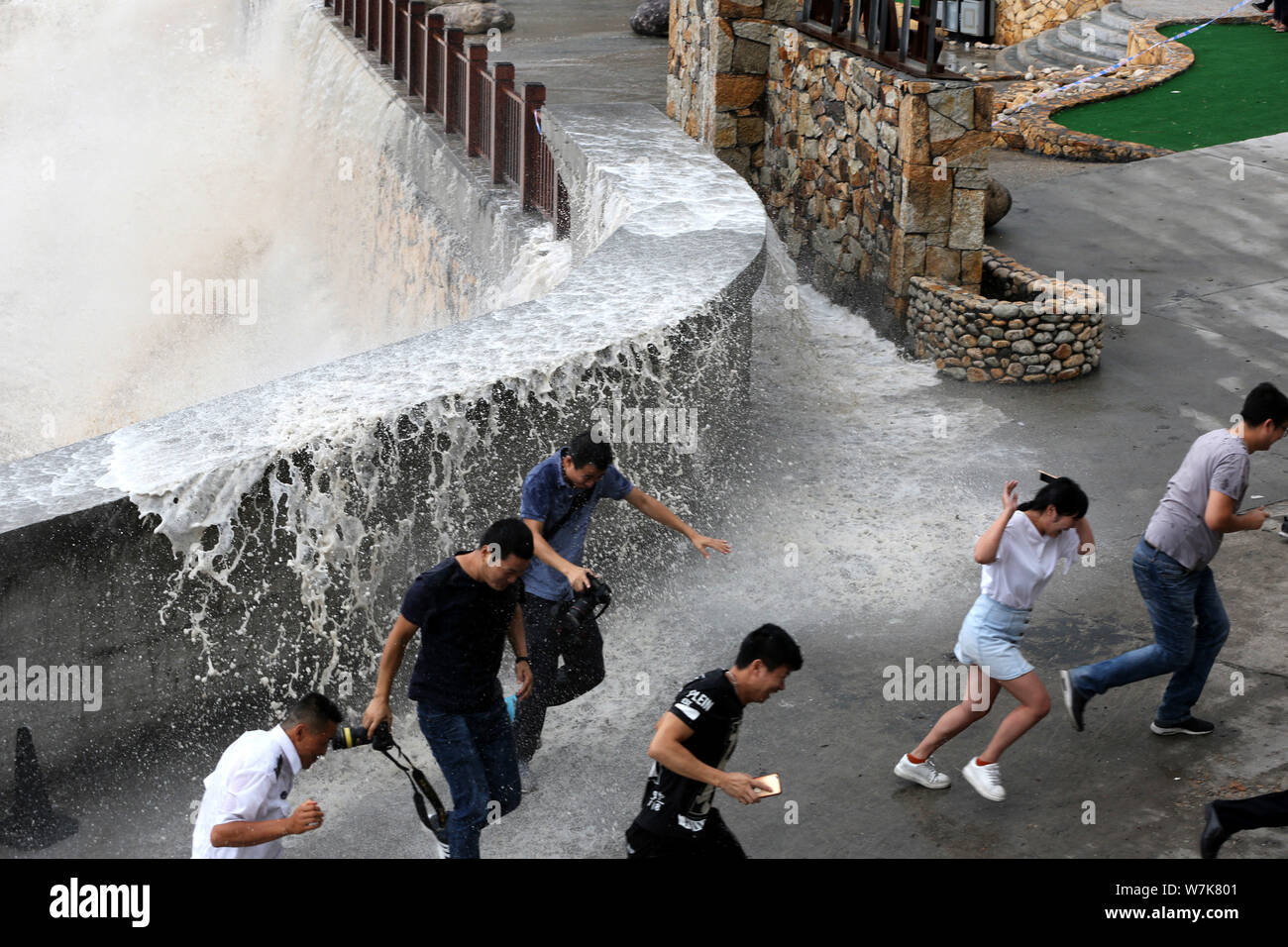 Local residents run away as massive waves from a tidal bore caused by ...