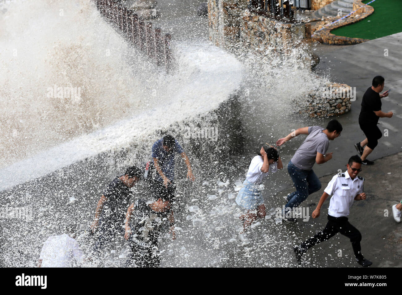 Local residents run away as massive waves from a tidal bore caused by ...