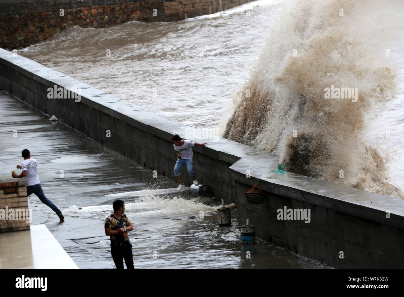 Local residents run away as massive waves from a tidal bore caused by ...