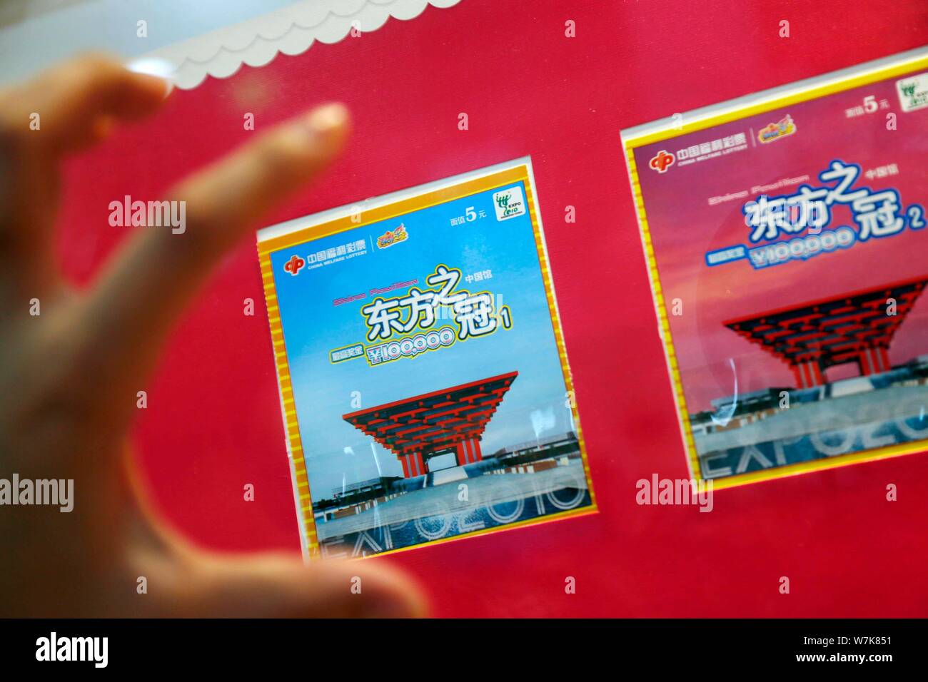 A visitor looks at a special lottery collection issued for Expo ...