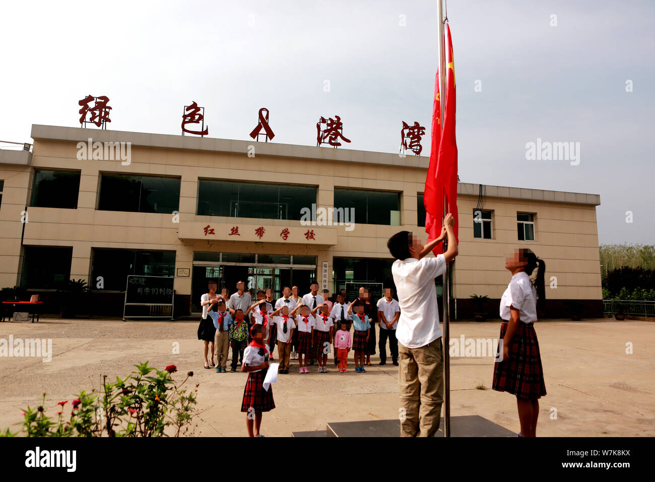 Chinese students are pictured during the ceremony of raising the ...