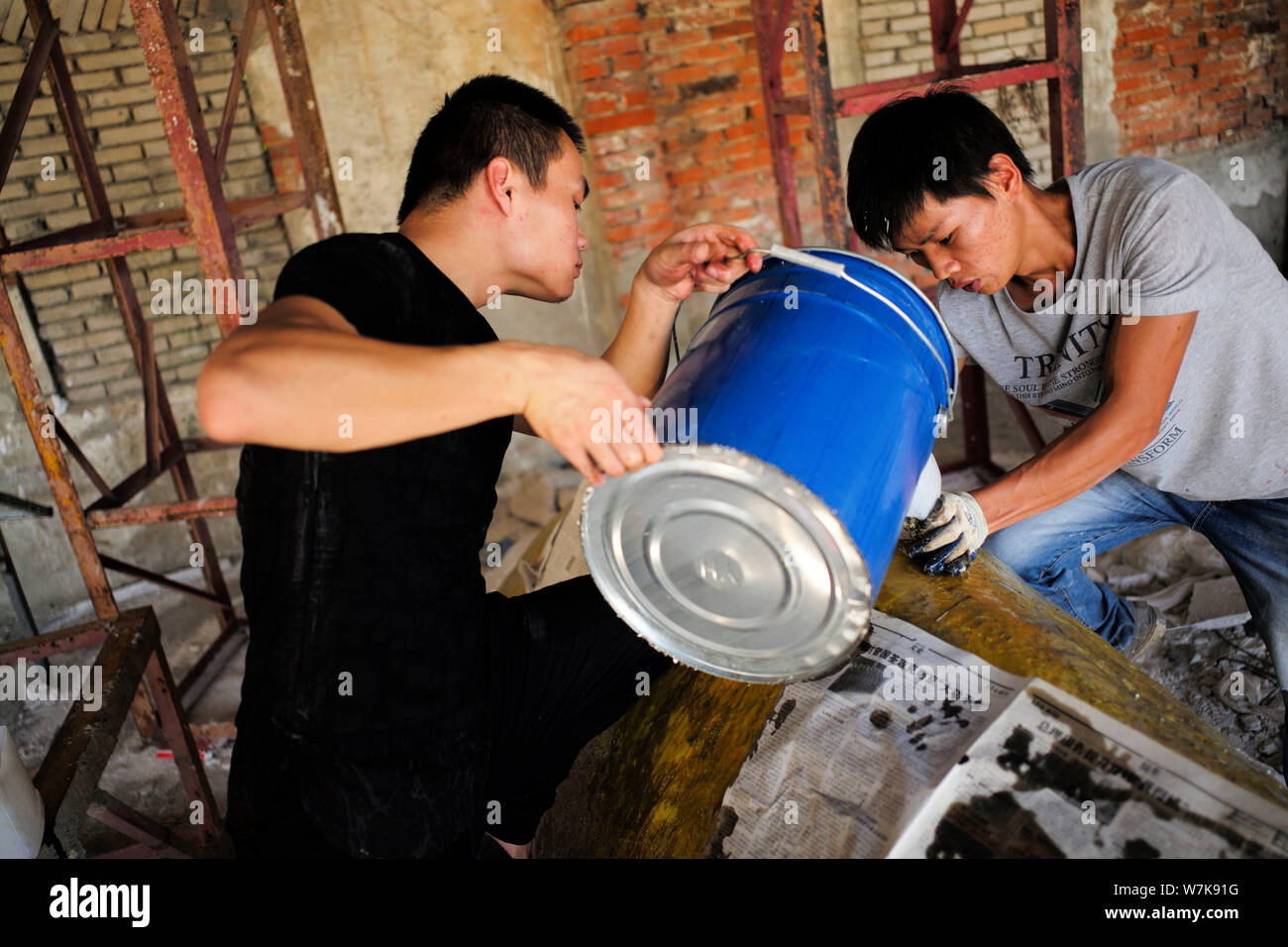 Chinese model airplane hobbyists Wan Li, left, and Huang Aibo build the ...