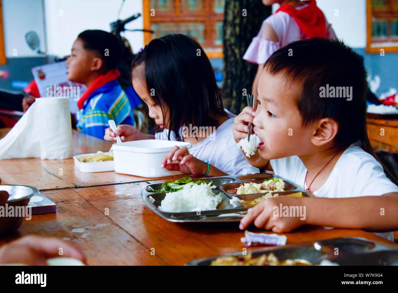 Chinese pupils take free lunch at the Gantuan Primary School in ...