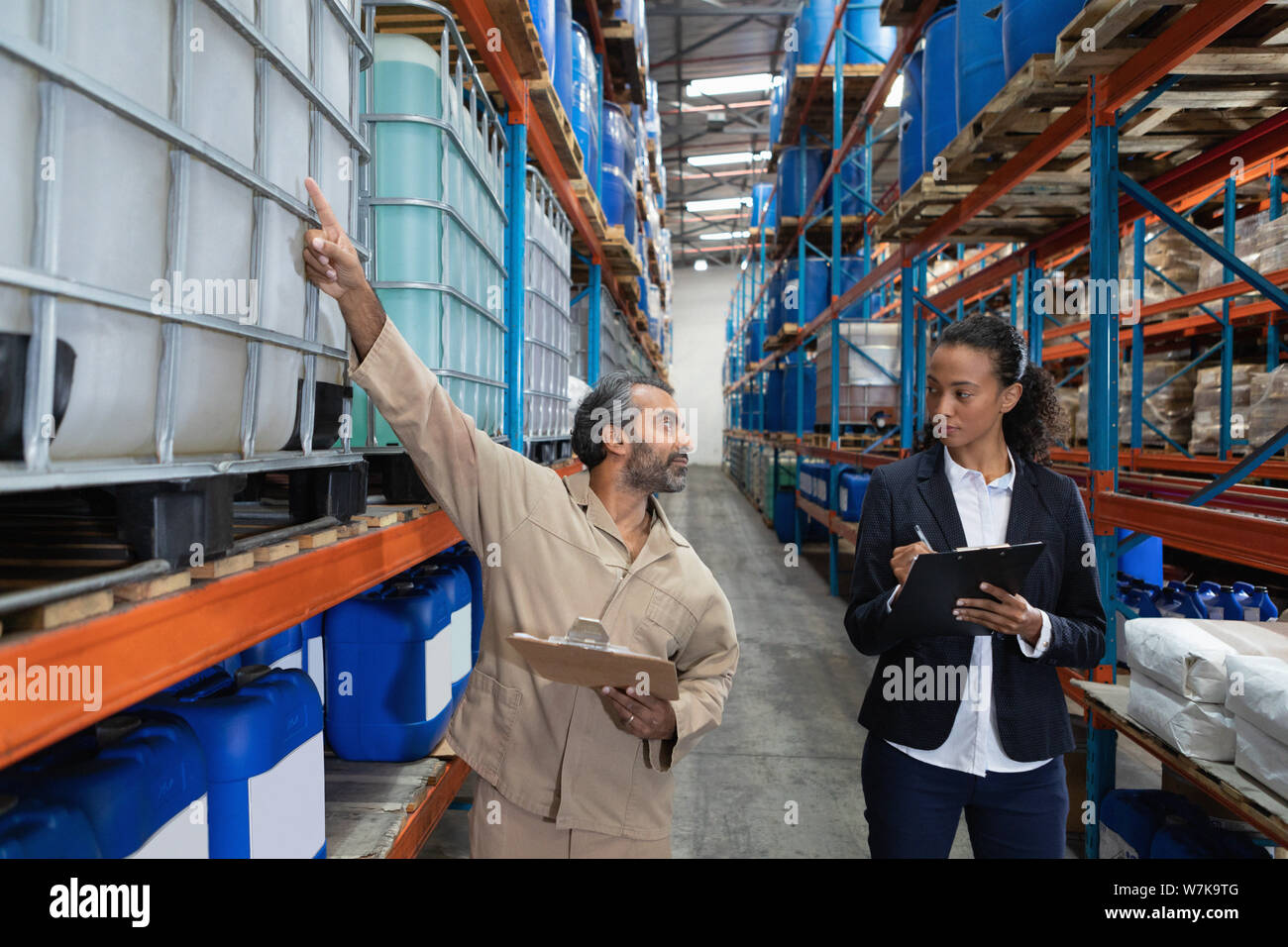 Female manager and male staff interacting with each other while ...