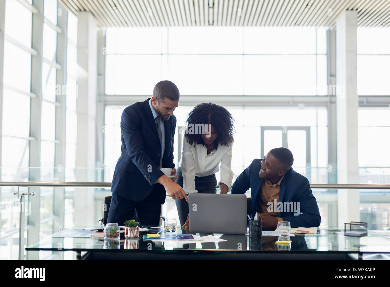 Three young business people working together Stock Photo - Alamy