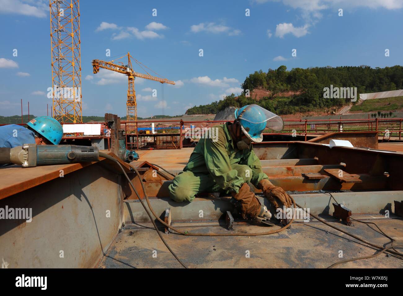 Chinese workers labor at the construction site of a full-scale replica ...