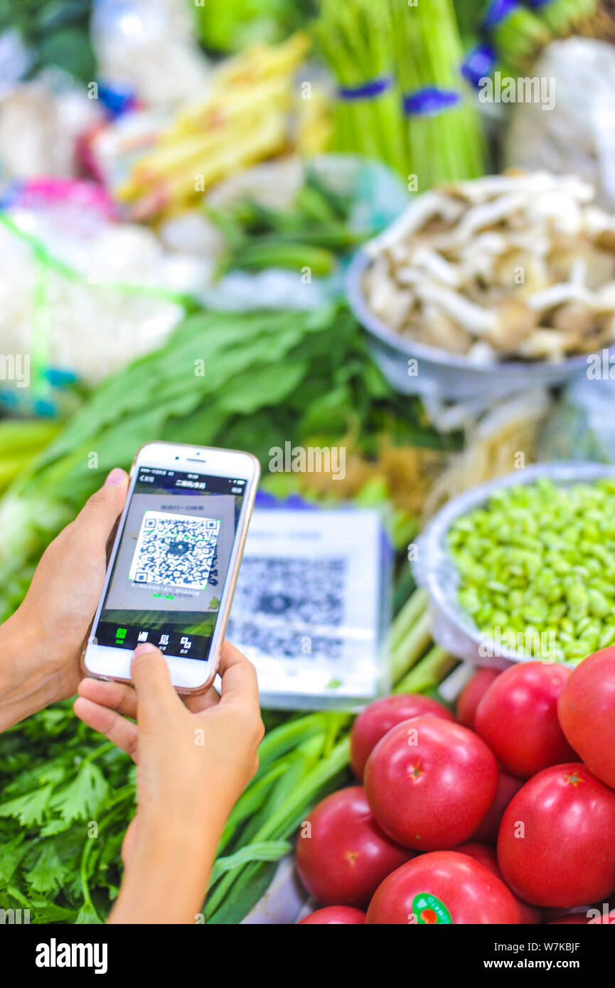 --FILE--A customer scans a QR code via mobile payment service Alipay of ...