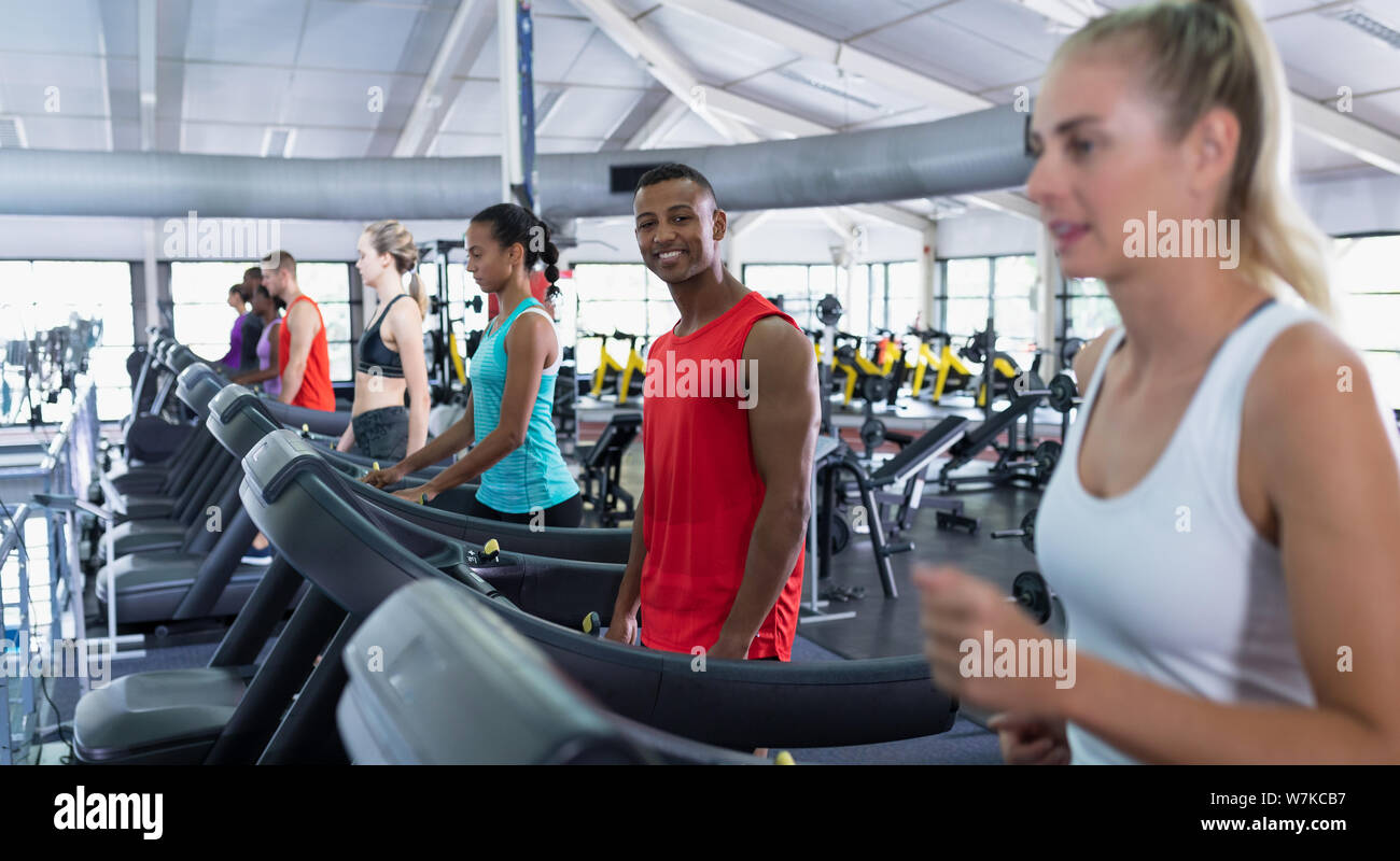 Fit man exercising on treadmill in fitness center Stock Photo - Alamy