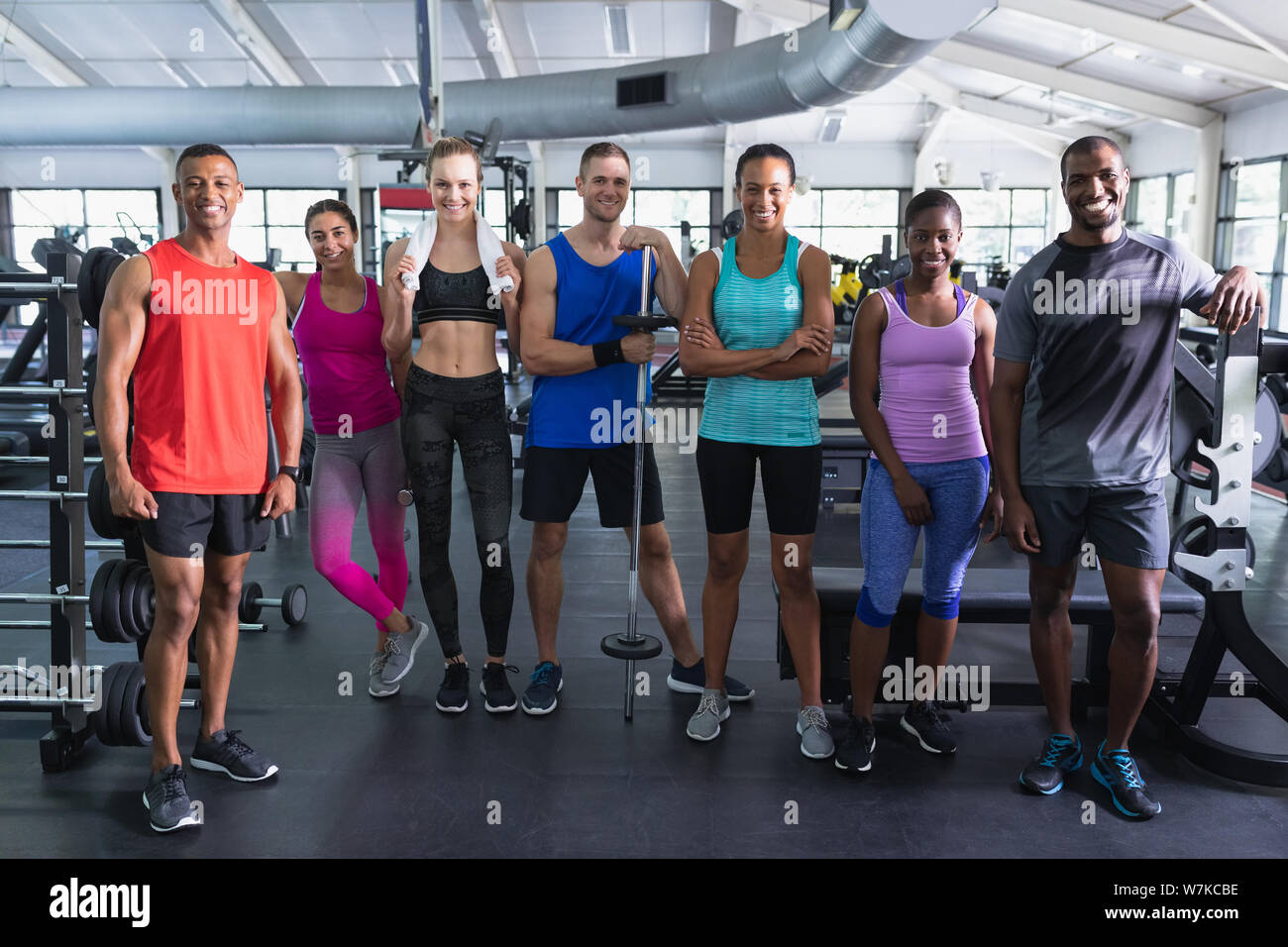 Fit people standing together in fitness center Stock Photo - Alamy