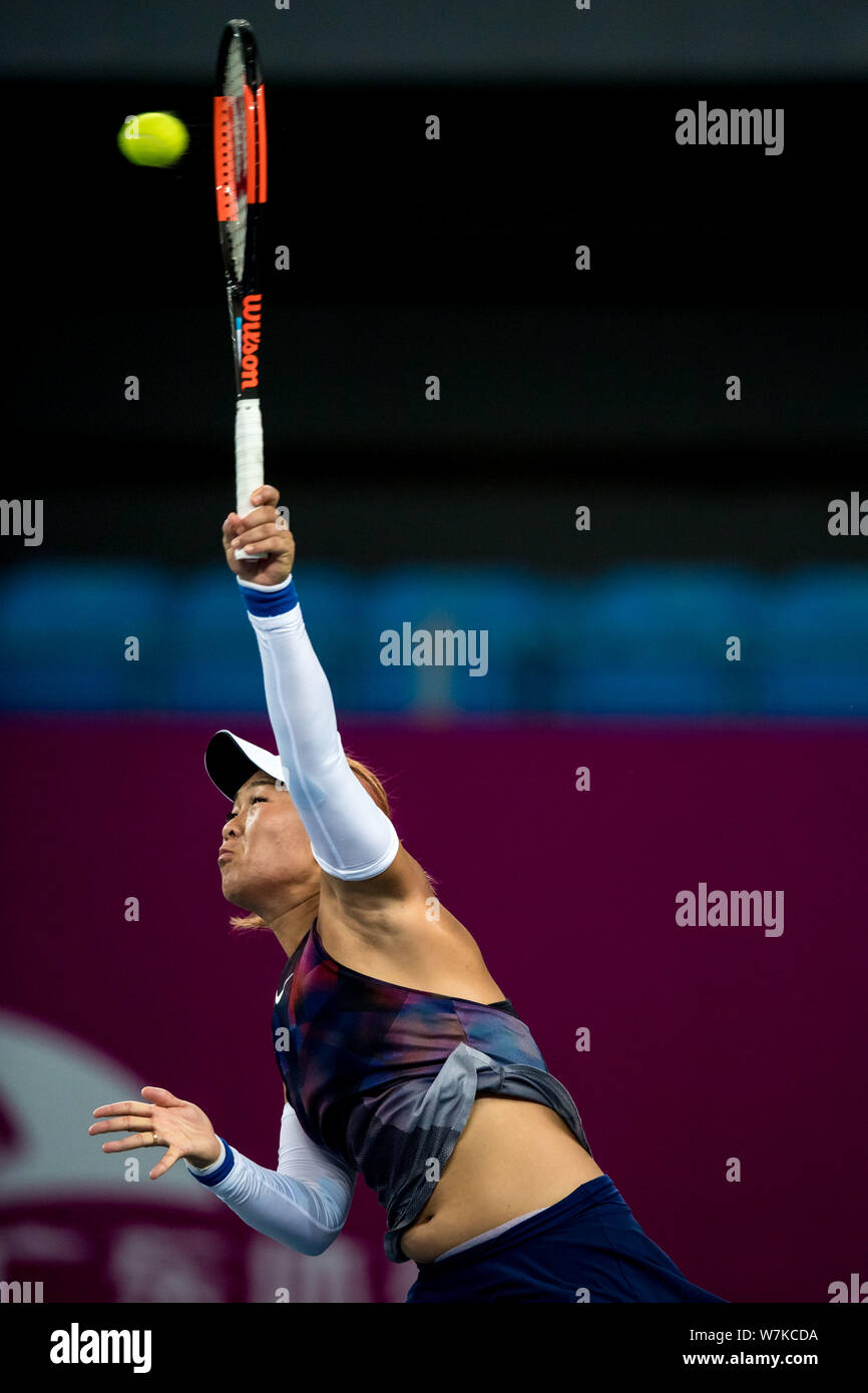Han Xinyun of China returns a shot to Samantha Stosur of Australia in ...
