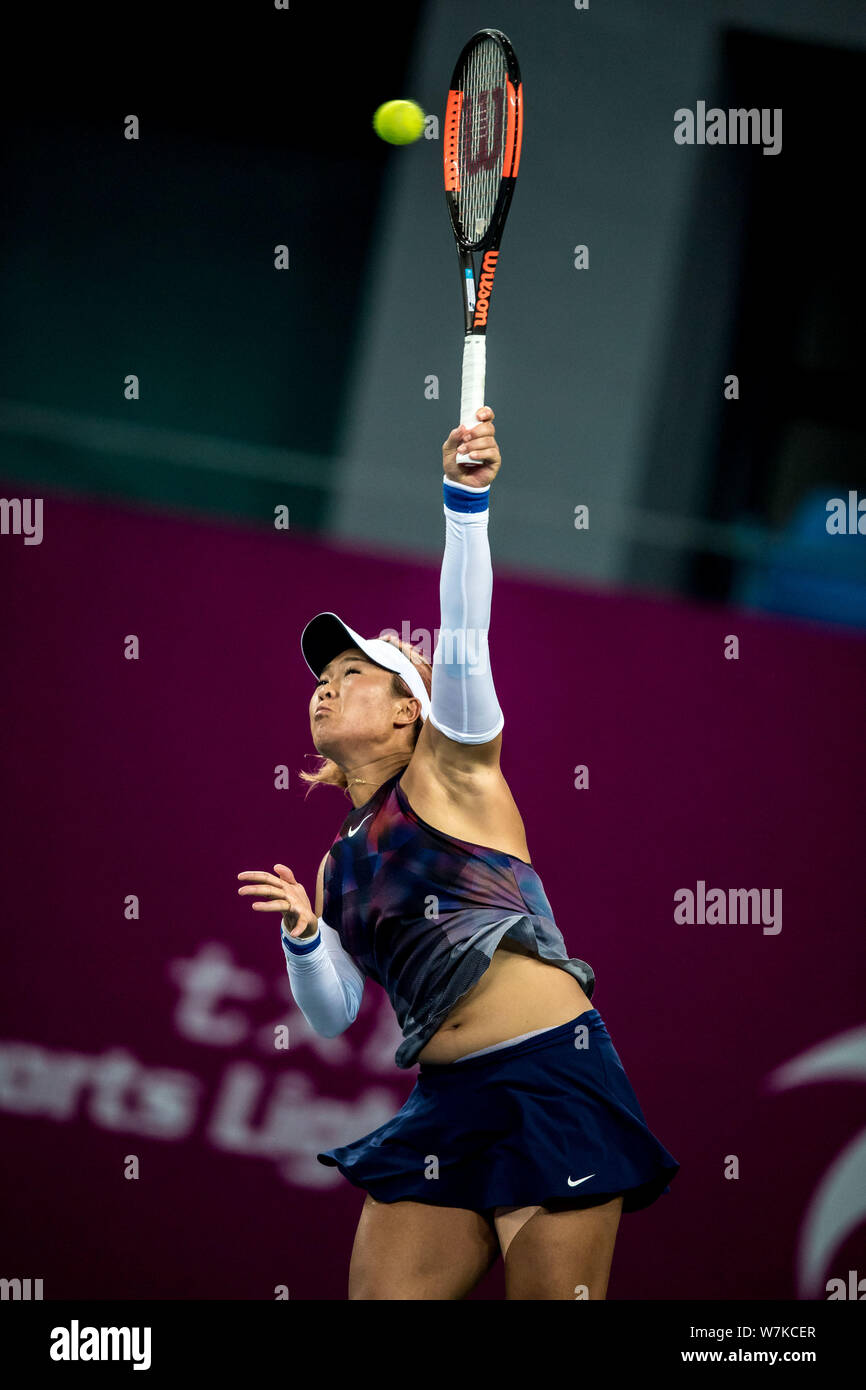 Han Xinyun of China returns a shot to Samantha Stosur of Australia in ...