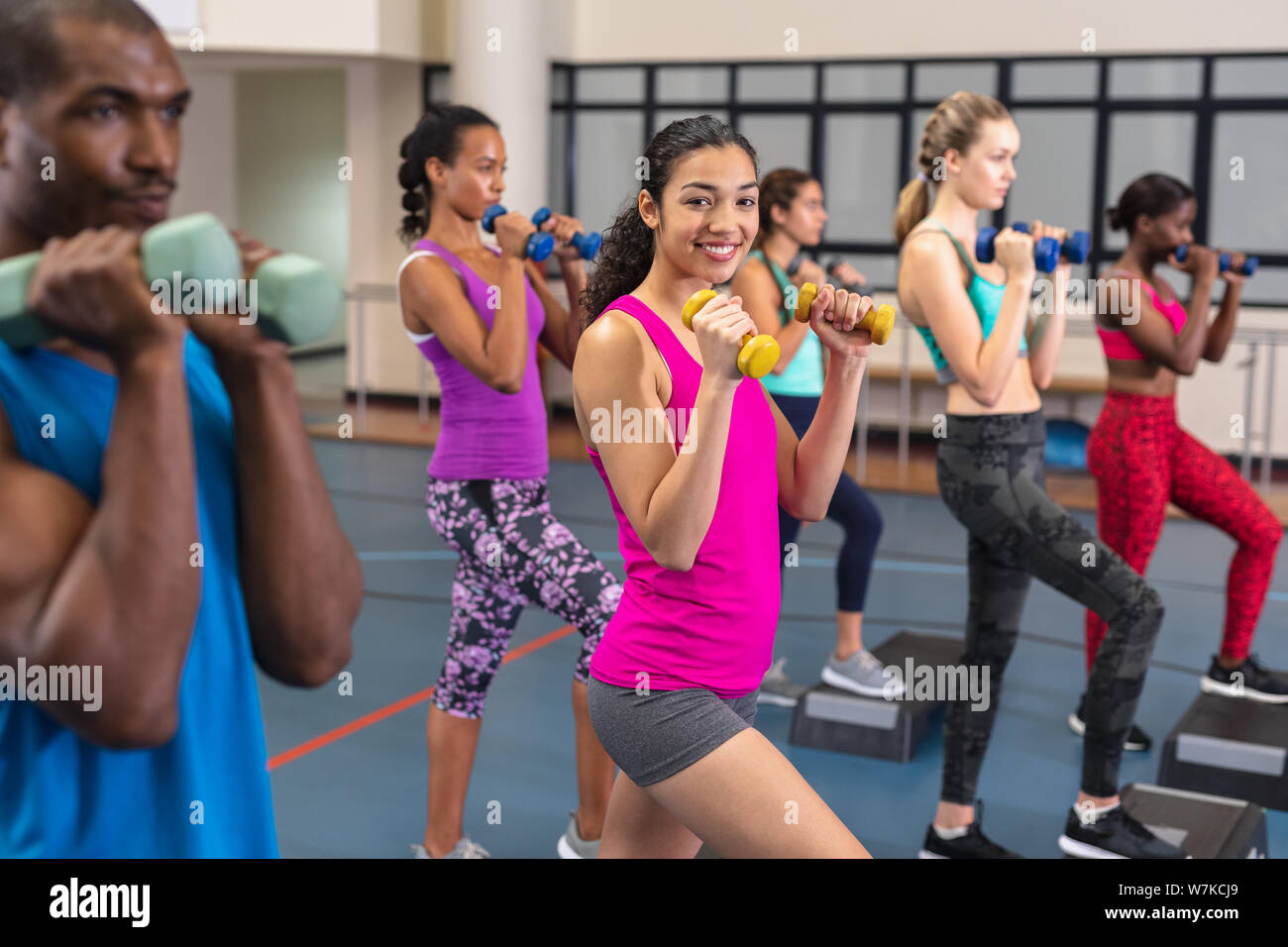 Fit people exercising with dumbbells on aerobic stepper Stock Photo - Alamy
