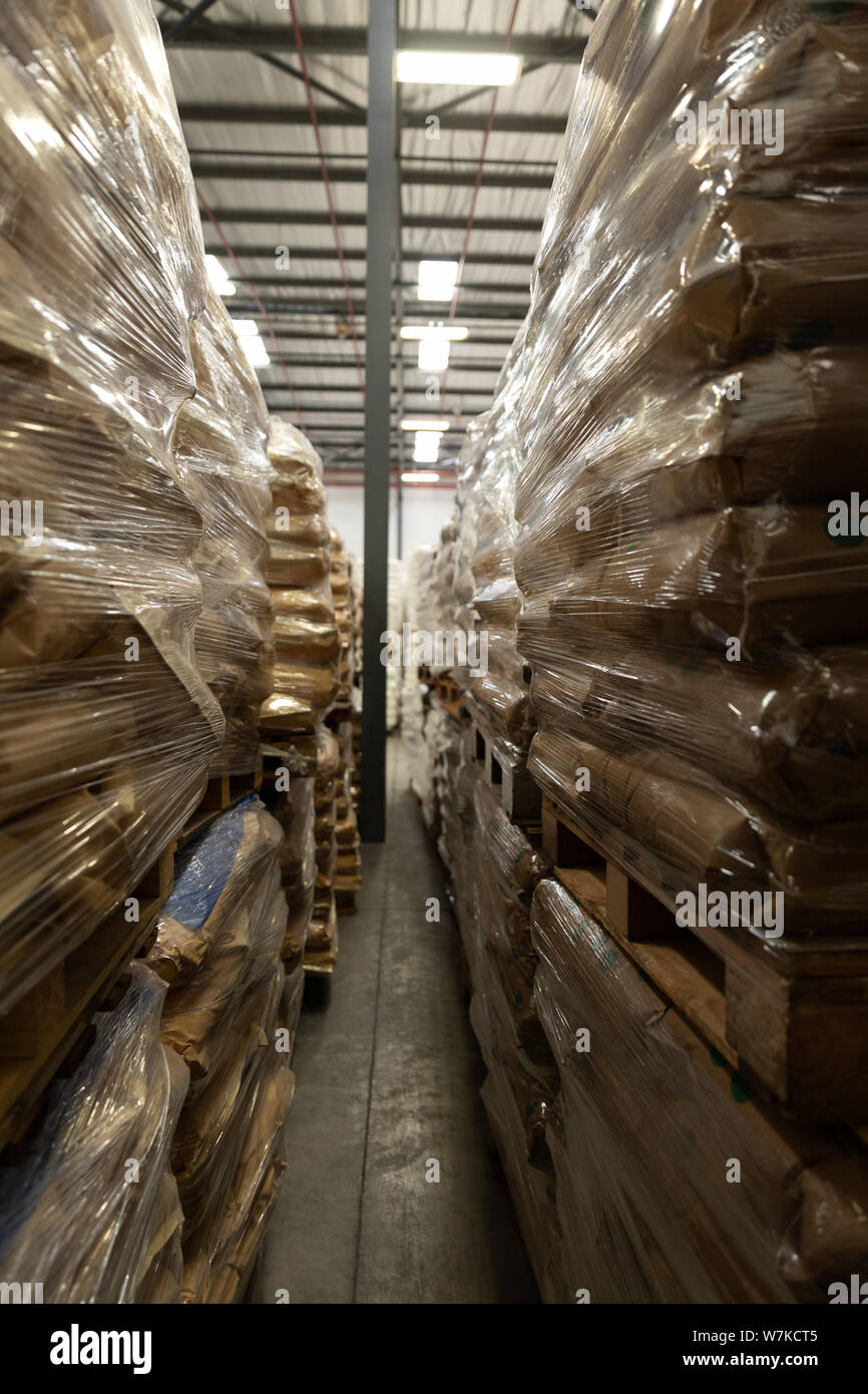 Packed goods on a rack in warehouse Stock Photo - Alamy