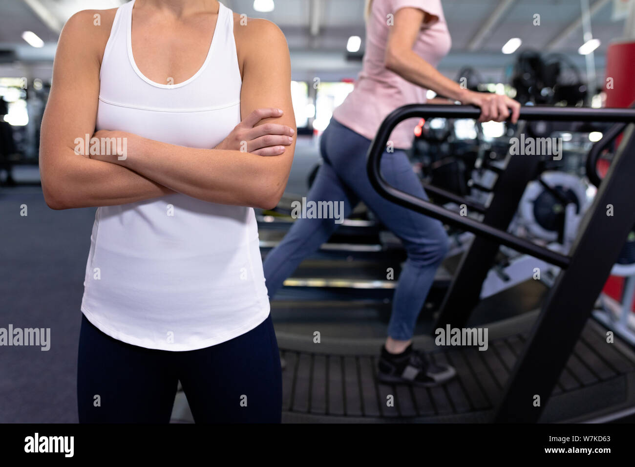 Woman standing with arm crossed in modern sports center Stock Photo - Alamy