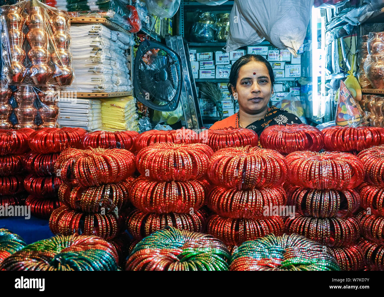 Indian woman selling bangles in a tiny shop at the basement of KR ...