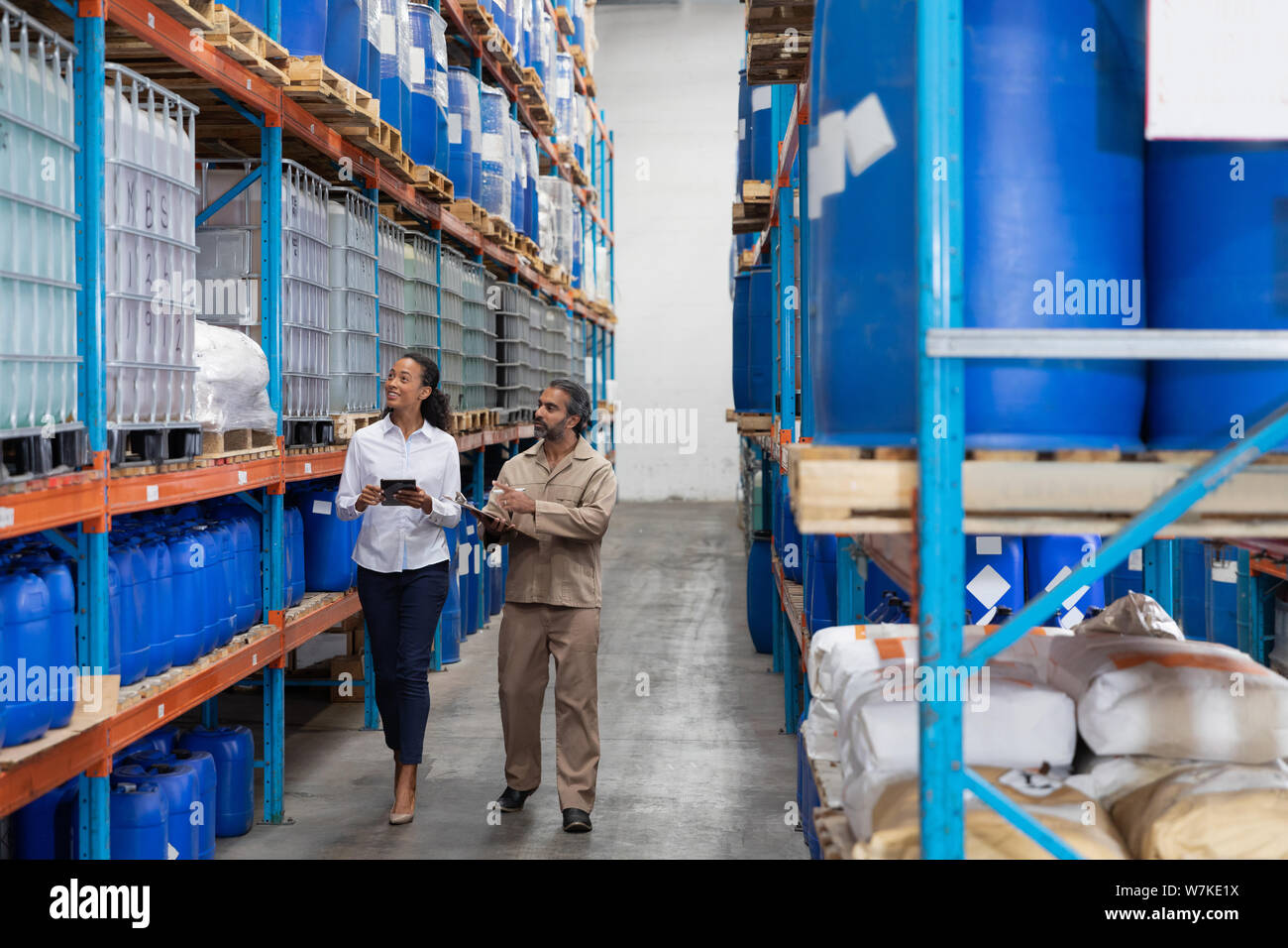 Female manger and male staff interacting with each other while checking ...