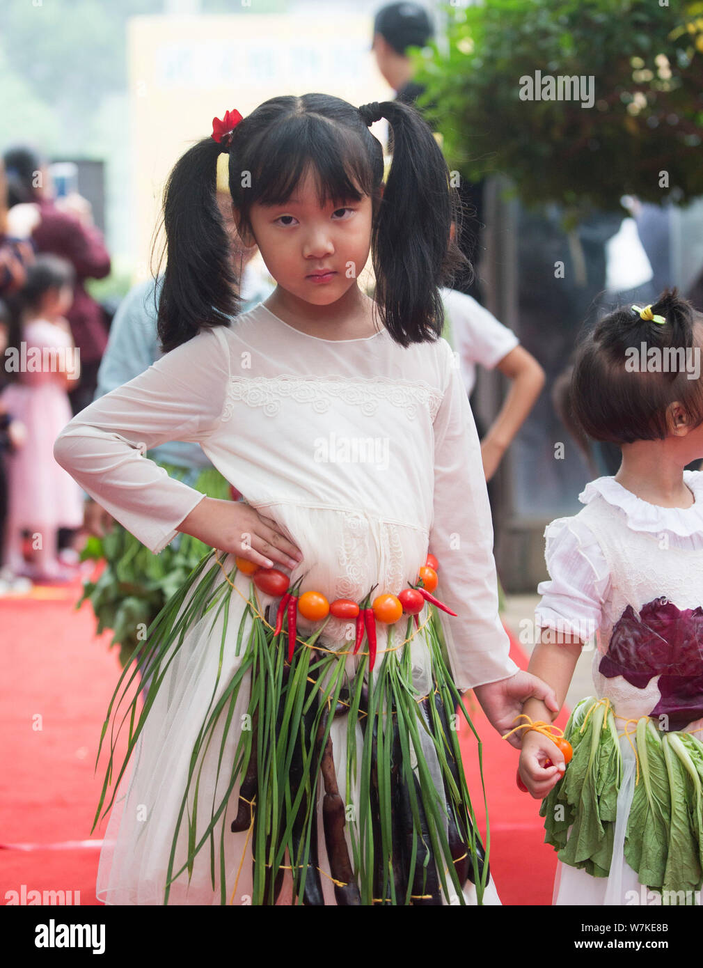 A child displays the ''clothes'' made of vegetables and fruits at a ...