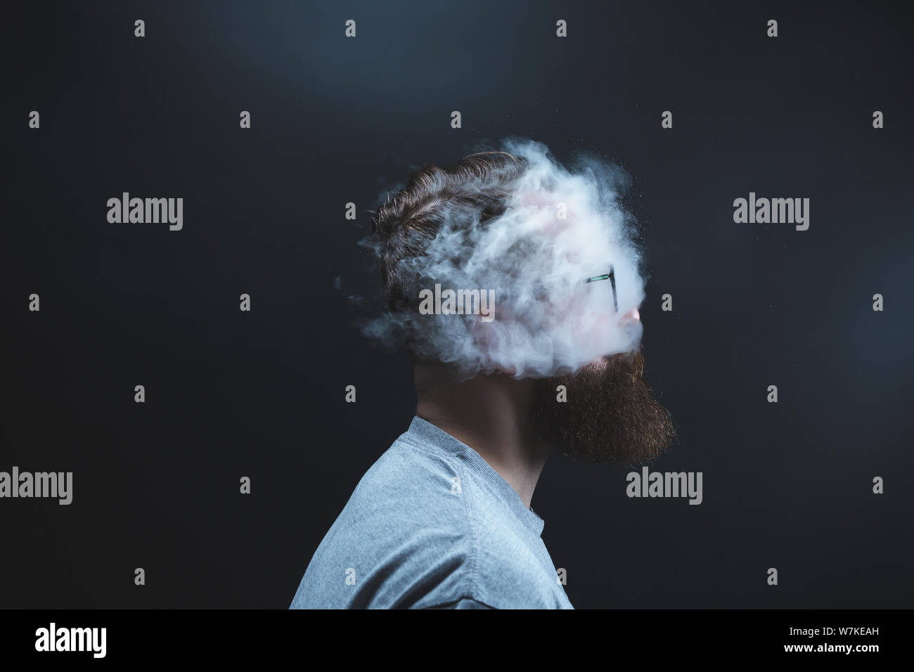 Concept. Smoke enveloped the head man. Portrait of a Bearded, stylish ...