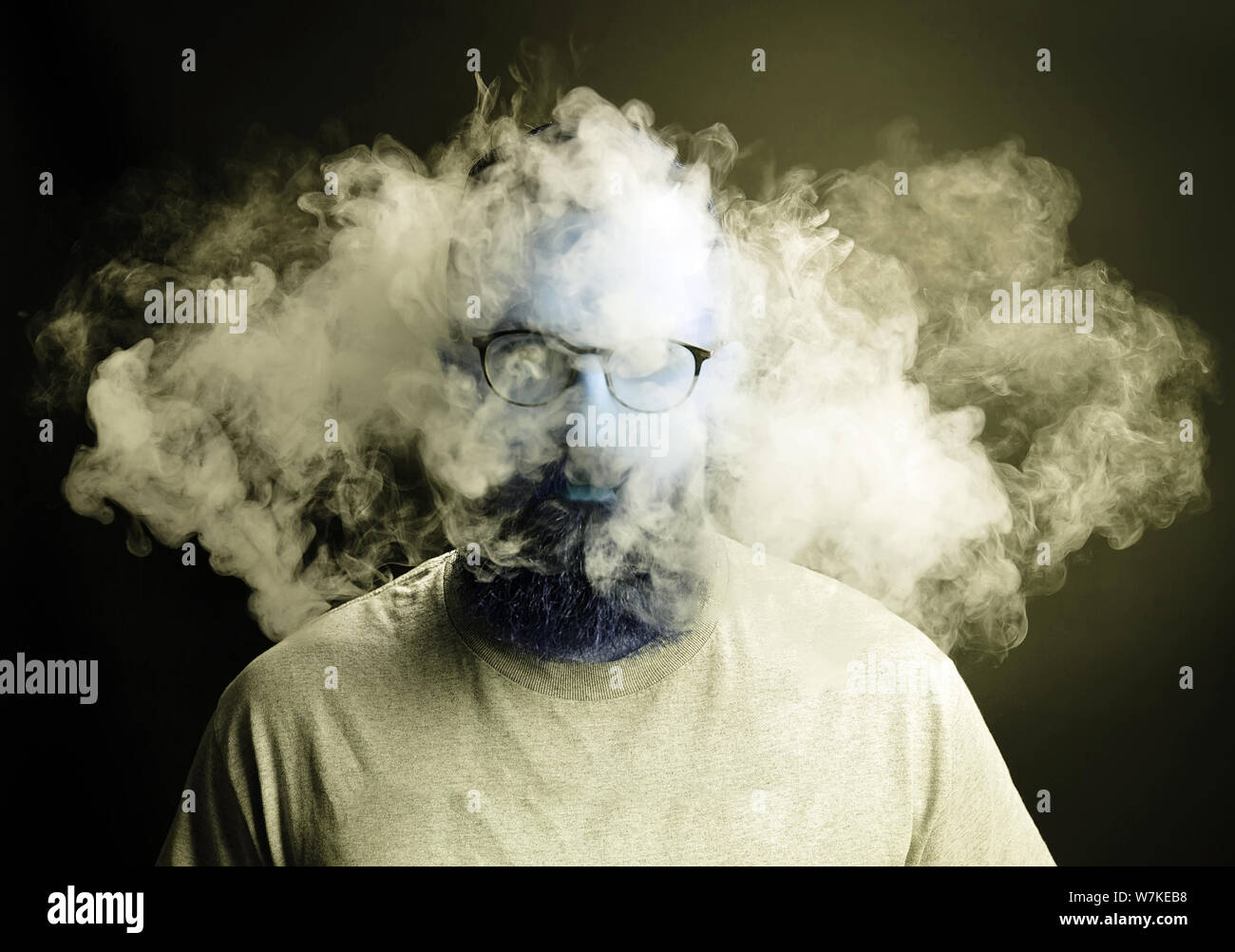 Concept. Smoke enveloped the head man. Portrait of a Bearded, stylish ...