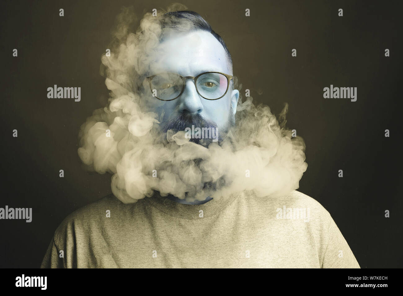 Concept. Smoke enveloped the head man. Portrait of a Bearded, stylish ...