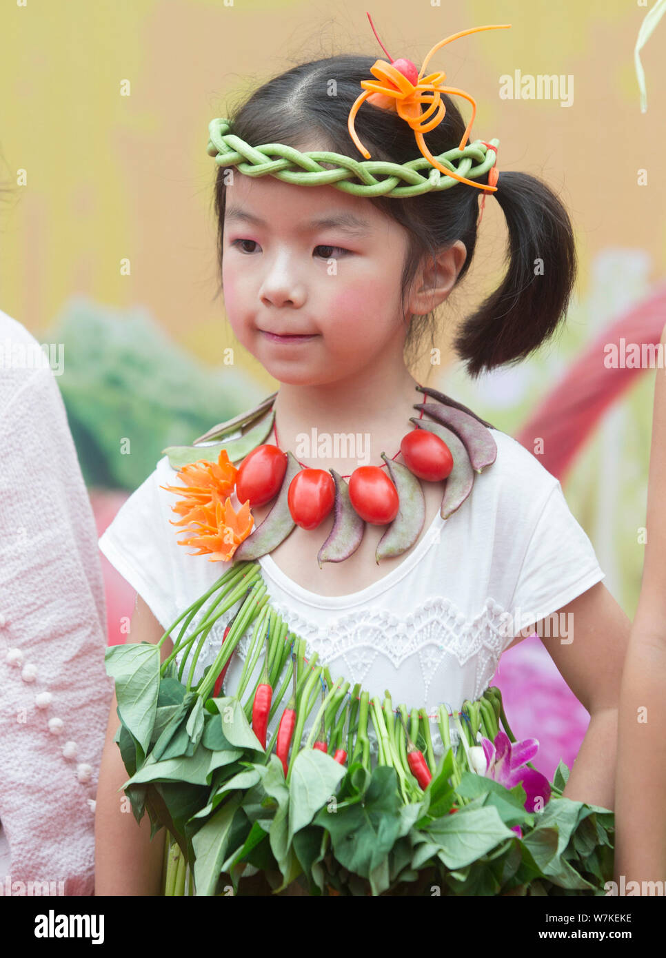 A child displays the ''clothes'' made of vegetables and fruits at a ...